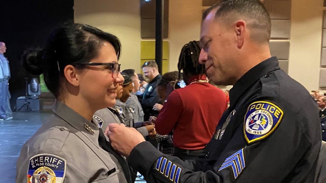 Calif. Police Officer Pins Badge on Colo. Deputy He Saved as Baby | Officer Calif. Police Officer Pins Badge on Colo. Deputy He Saved as Baby | Officer