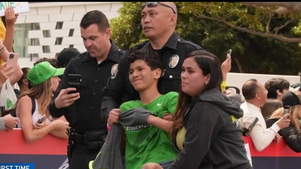 Watch LAPD Officer Help Carry Teen Runner Across Marathon Finish Line ...